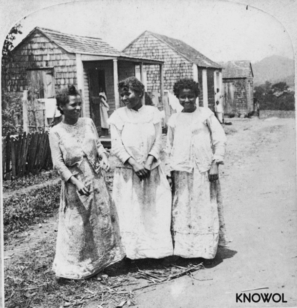 Three native Puerto Rican women in front of their hut houses - KNOWOL